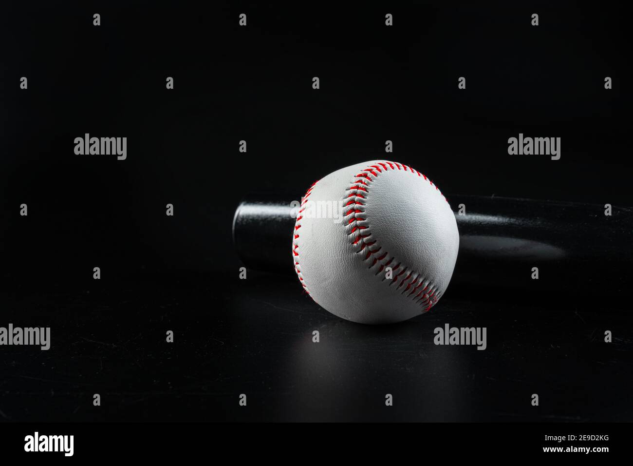 Baseball game equipment on dark black background Stock Photo - Alamy