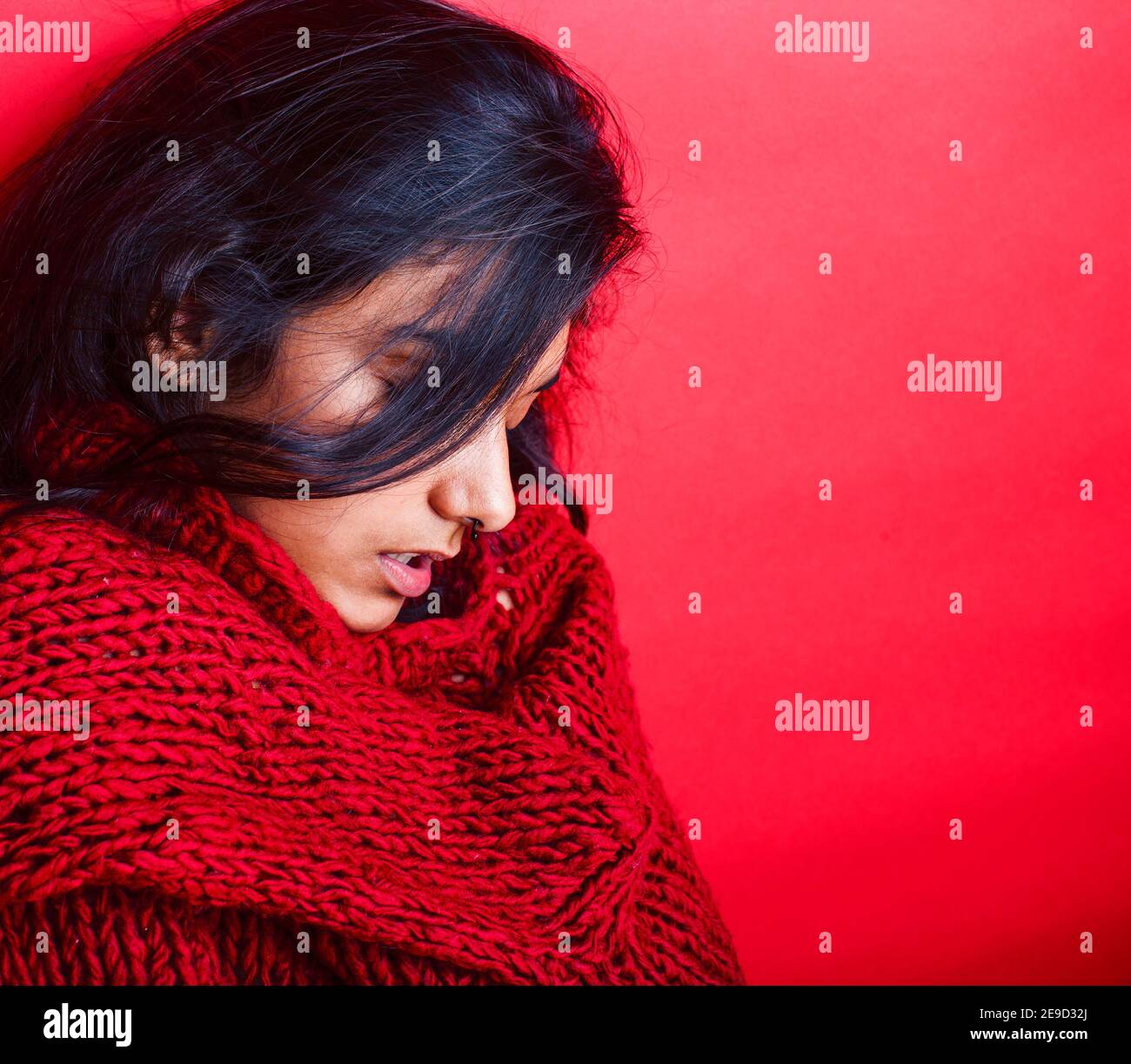 young pretty indian girl in red sweater posing emotional, fashion ...