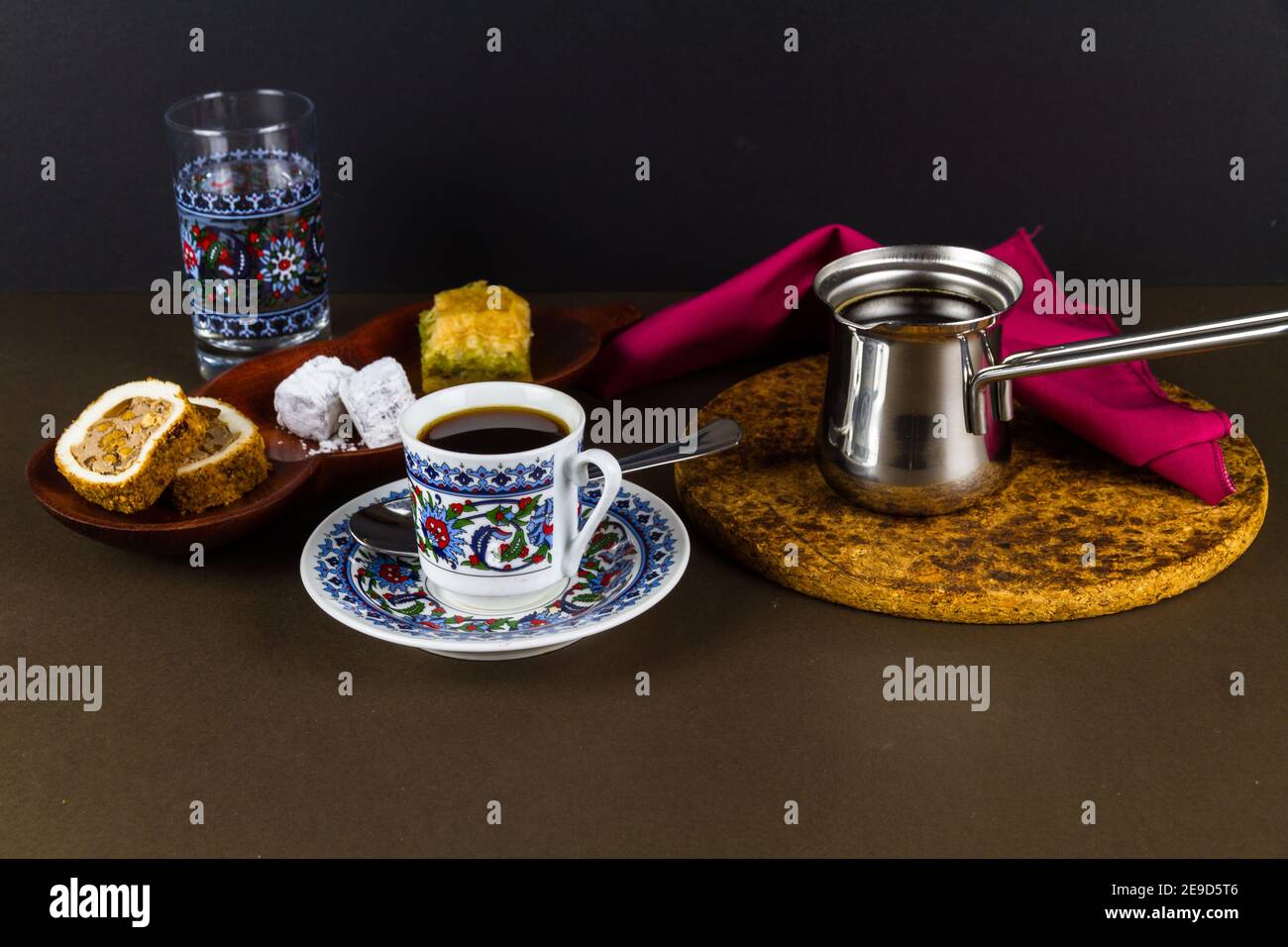 Turkish coffee in cezve with cup, saucer, water glass served with ...