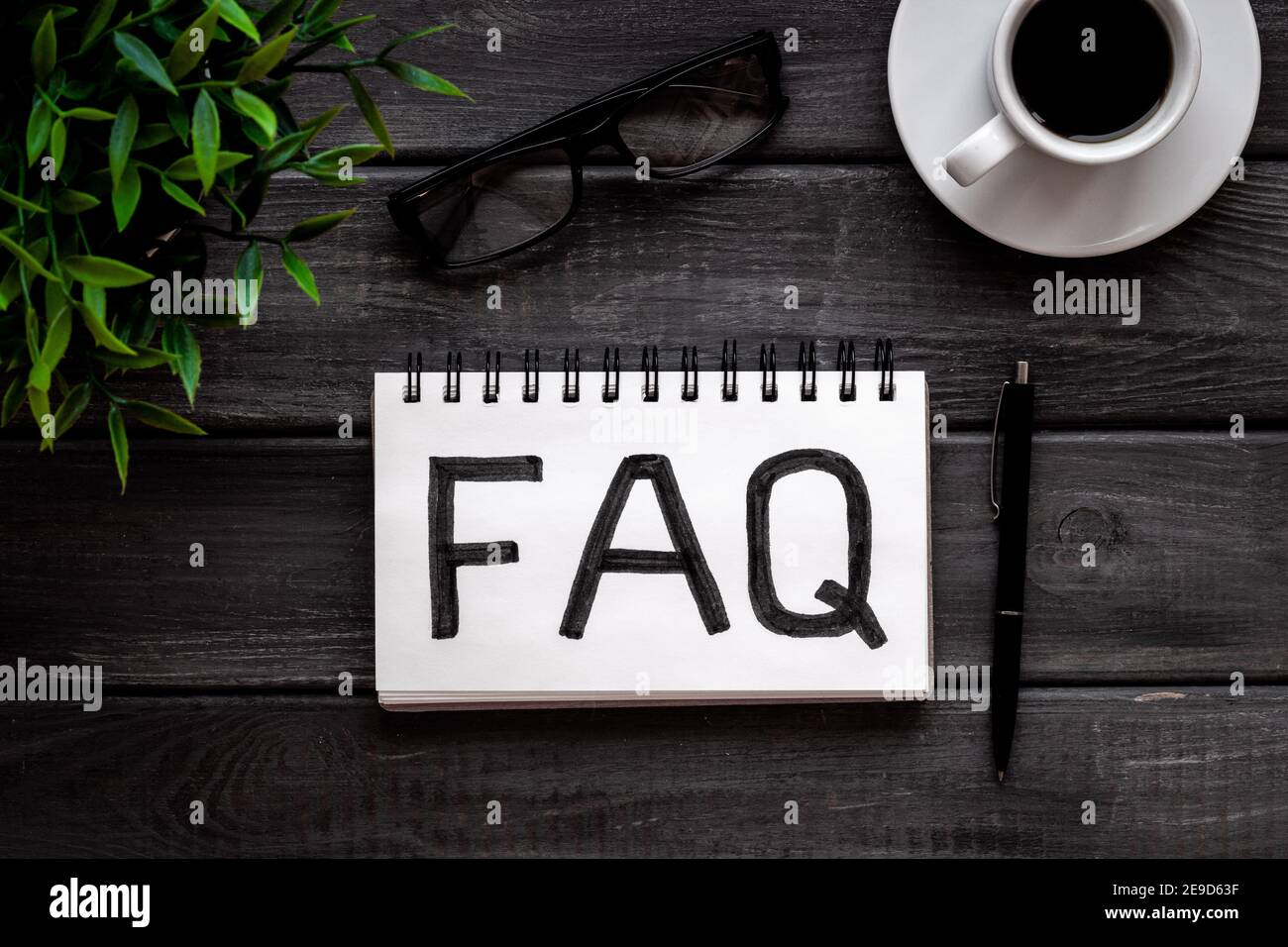 FAQ on office desk. Working with clients concept Stock Photo - Alamy
