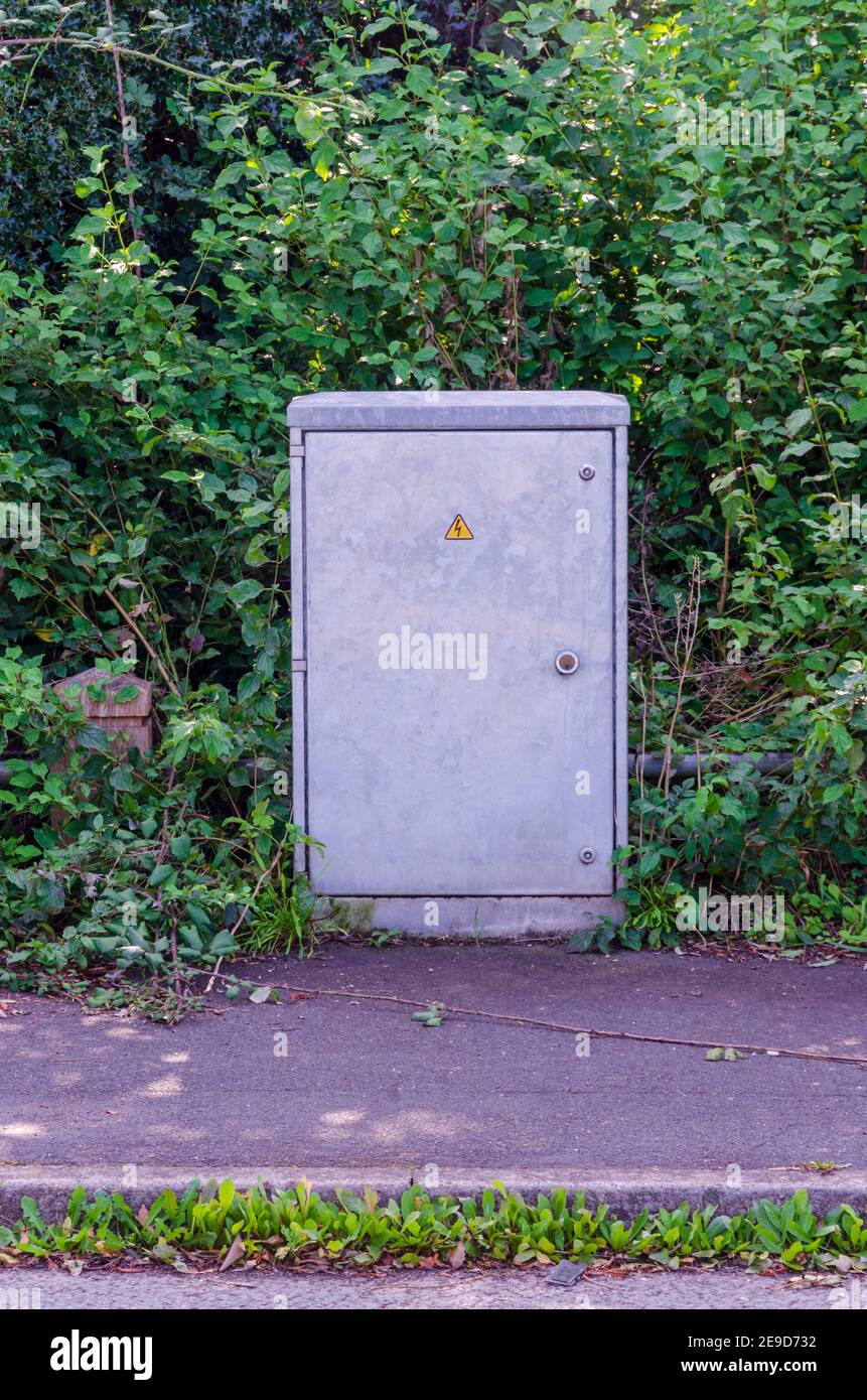 Bare metal street power or telecoms cabinet with a small warning ...