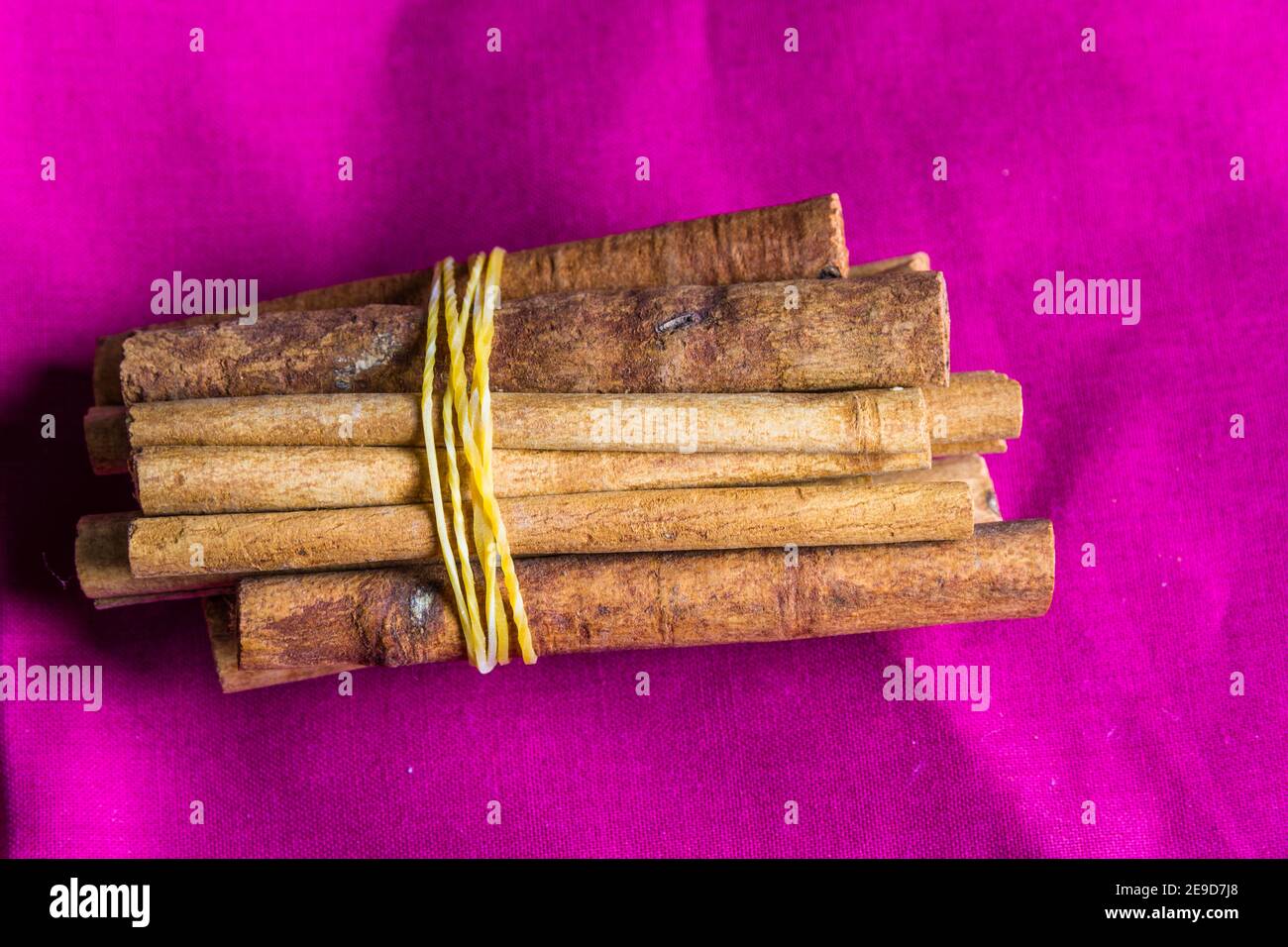 Cinnamon sticks or bark on red cloth, landscape Stock Photo - Alamy