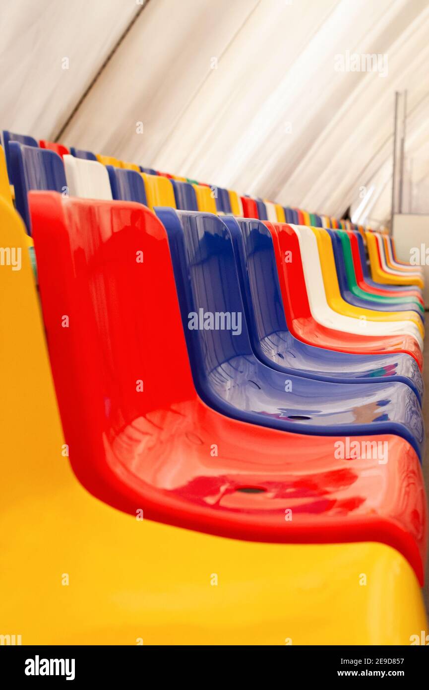 Multi-colored seats. Indoor ice rink. Sports stadium, stands for fans ...