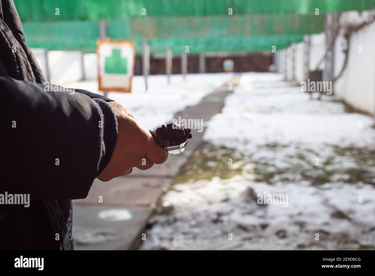 A man reloads a gun. Winter, out of the door, shooting range. Murder ...