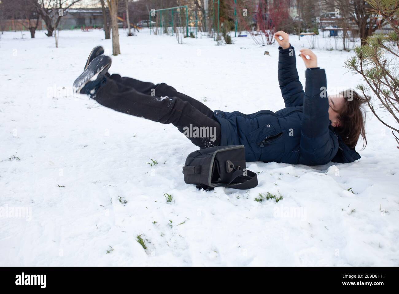 A man falls in the snow. The man slipped and was injured. Falling on ...