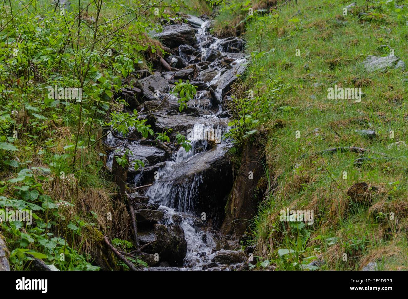 small waterfall over rocks in mountain Stock Photo - Alamy