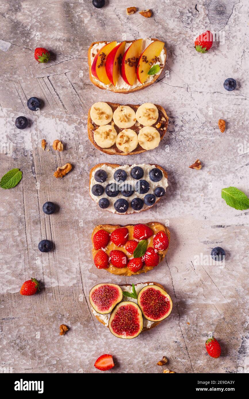 Homemade summer toast with cream cheese, nut butter and fruits and ...