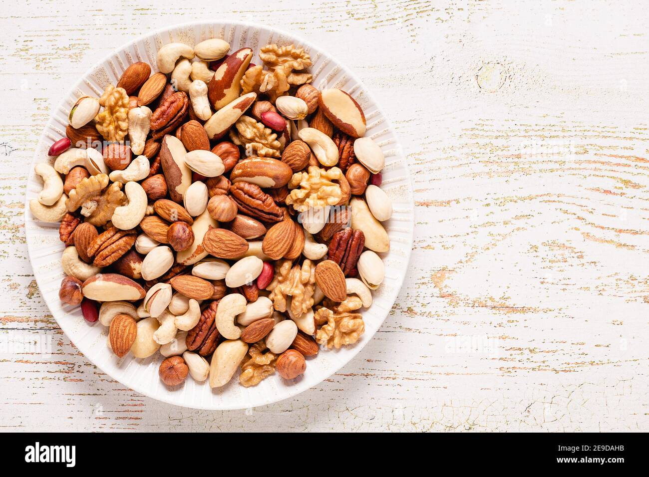 Various nuts on a plate, top view Stock Photo - Alamy
