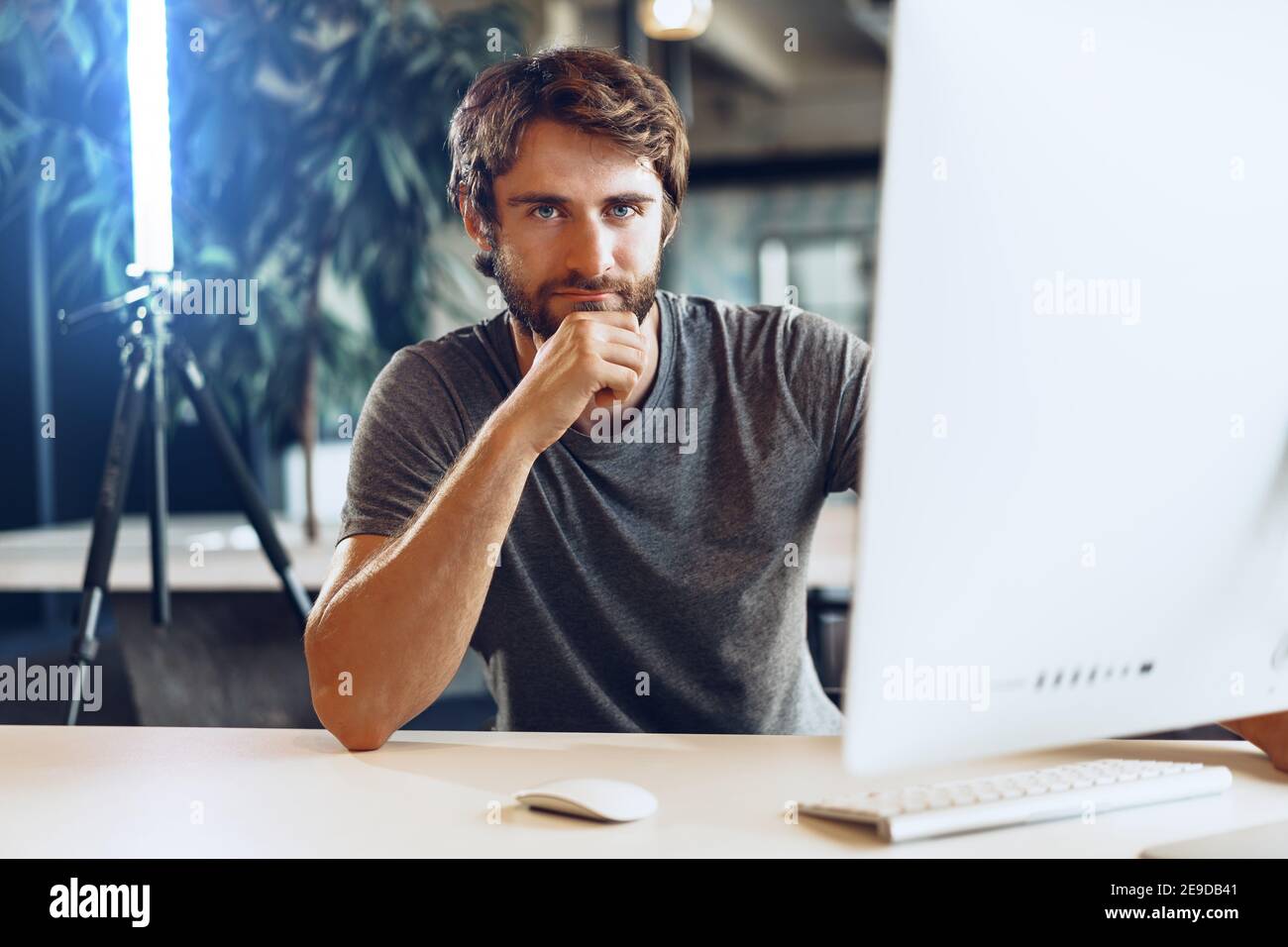 Bearded man freelancer using computer in a modern coworking place Stock ...