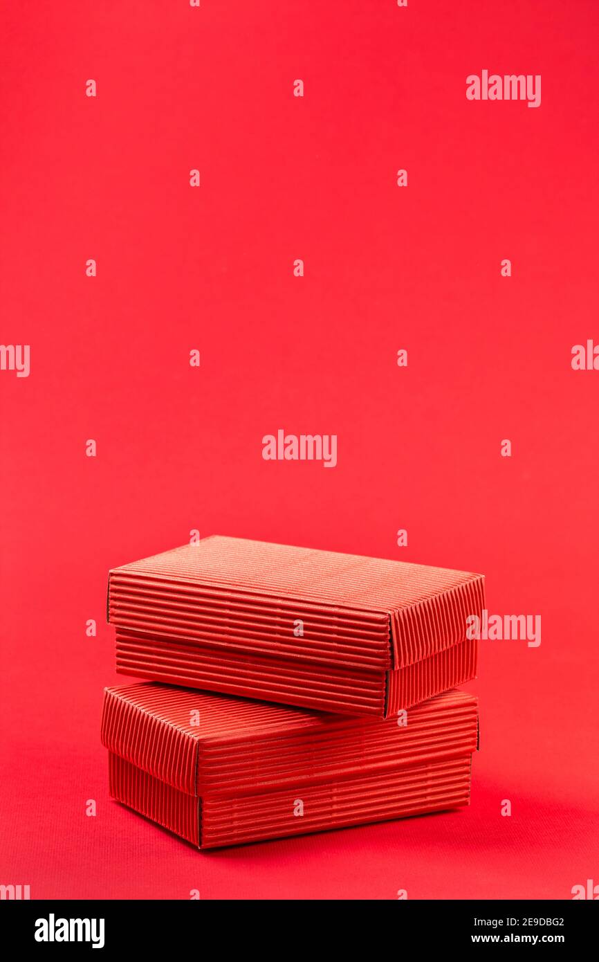 Monochromatic photo of two red closed corrugated cardboard boxes on red ...