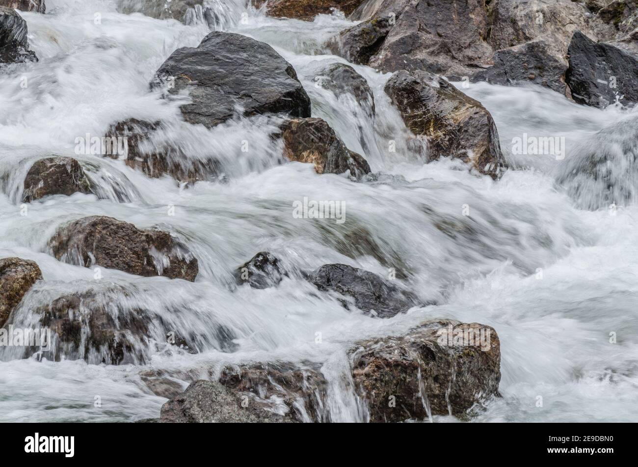 foaming water over rocks in stream Stock Photo - Alamy