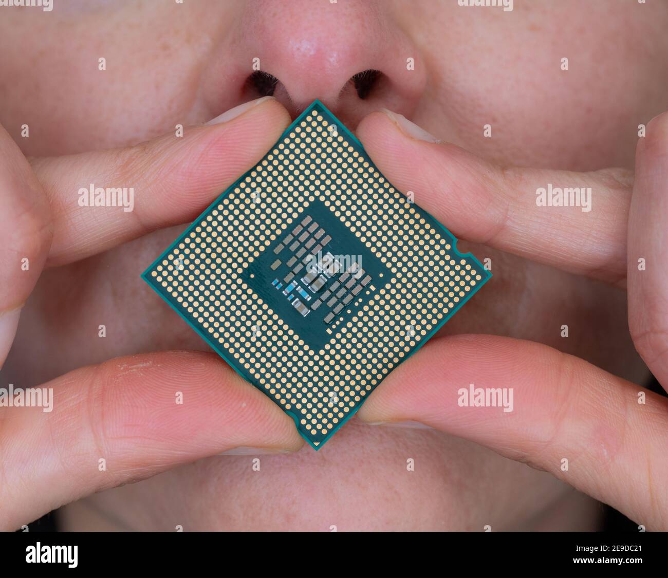 Computer cpu chip over the mouth, front view Stock Photo - Alamy