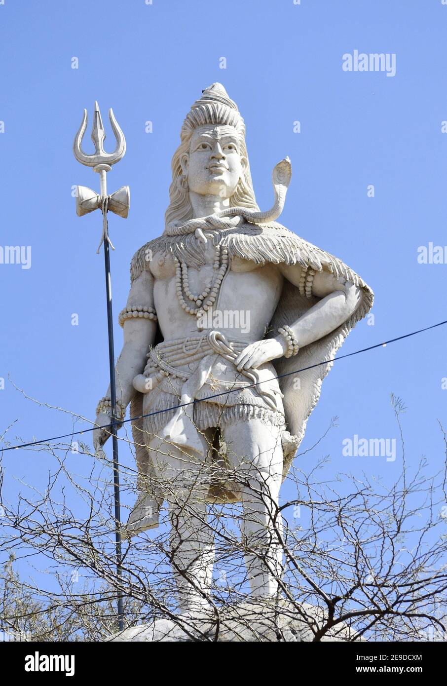 Vertical closeup of the statue of Lord Shiva against a blue sky Stock ...