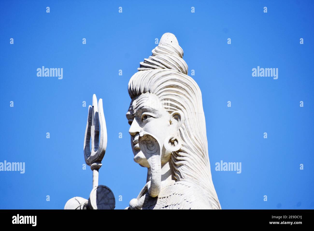 Side view of the statue of Lord Shiva against a blue sky Stock Photo ...