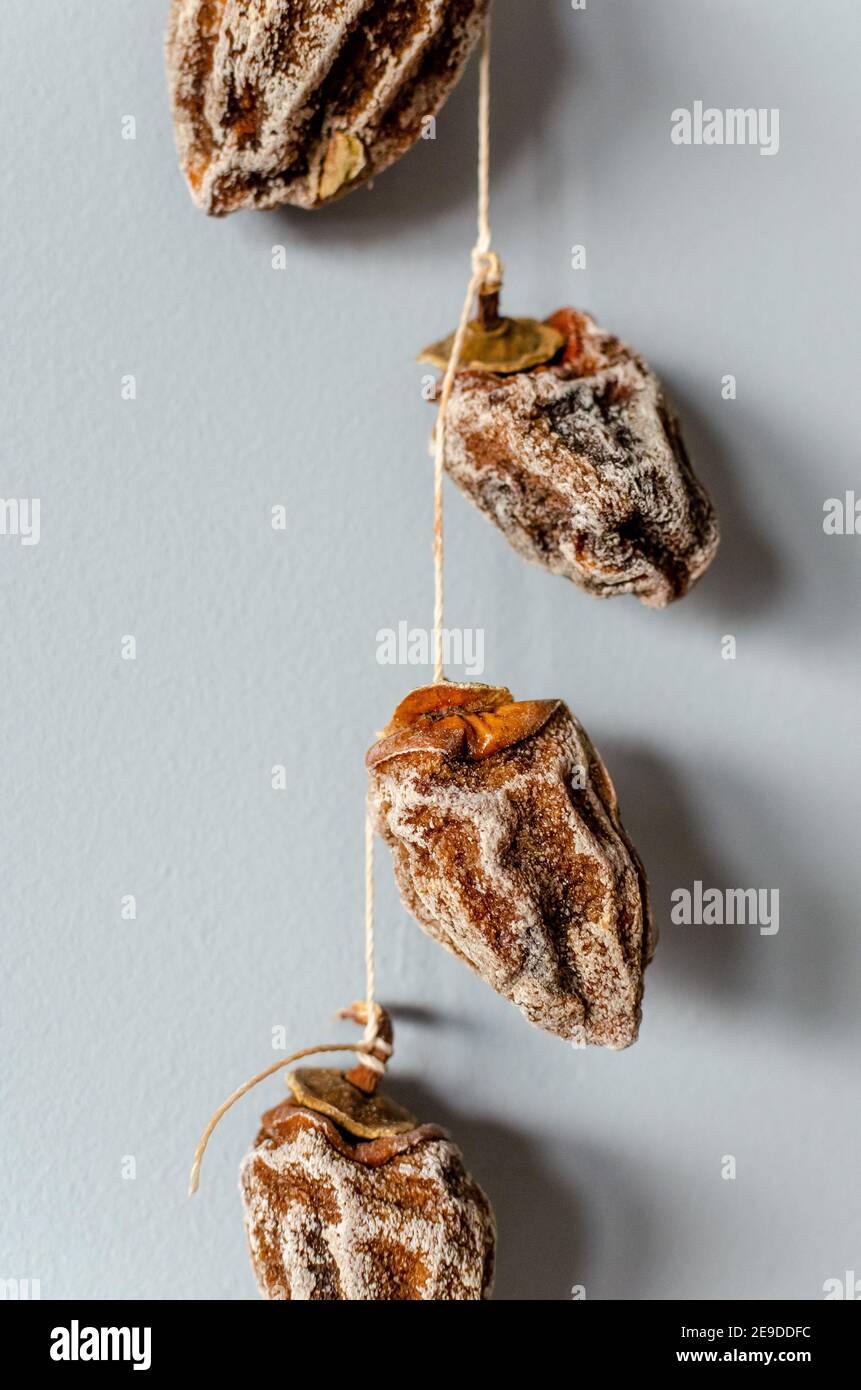 Persimmons hanging hi-res stock photography and images - Alamy