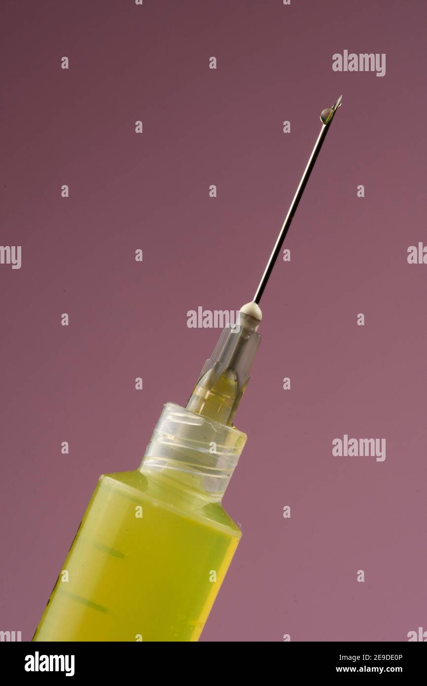 injection syringe with needle detail on colored background with space ...