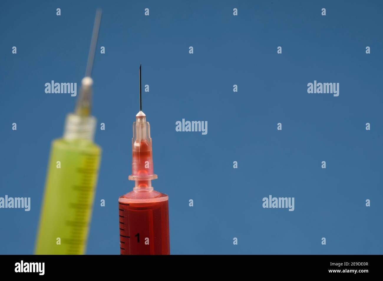 injection syringe with needle detail on colored background with space ...