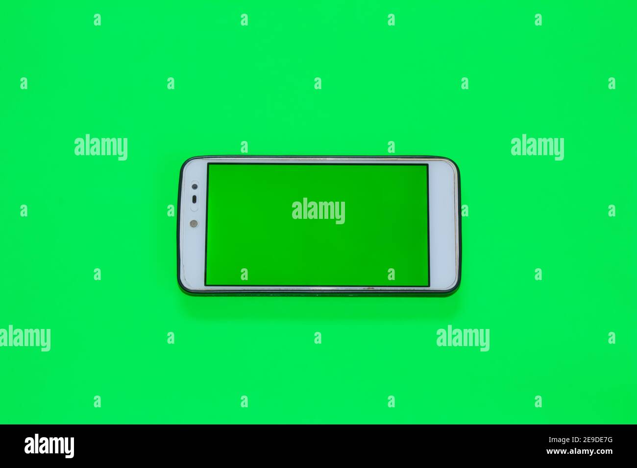 Smartphone with green screen on green background Stock Photo - Alamy