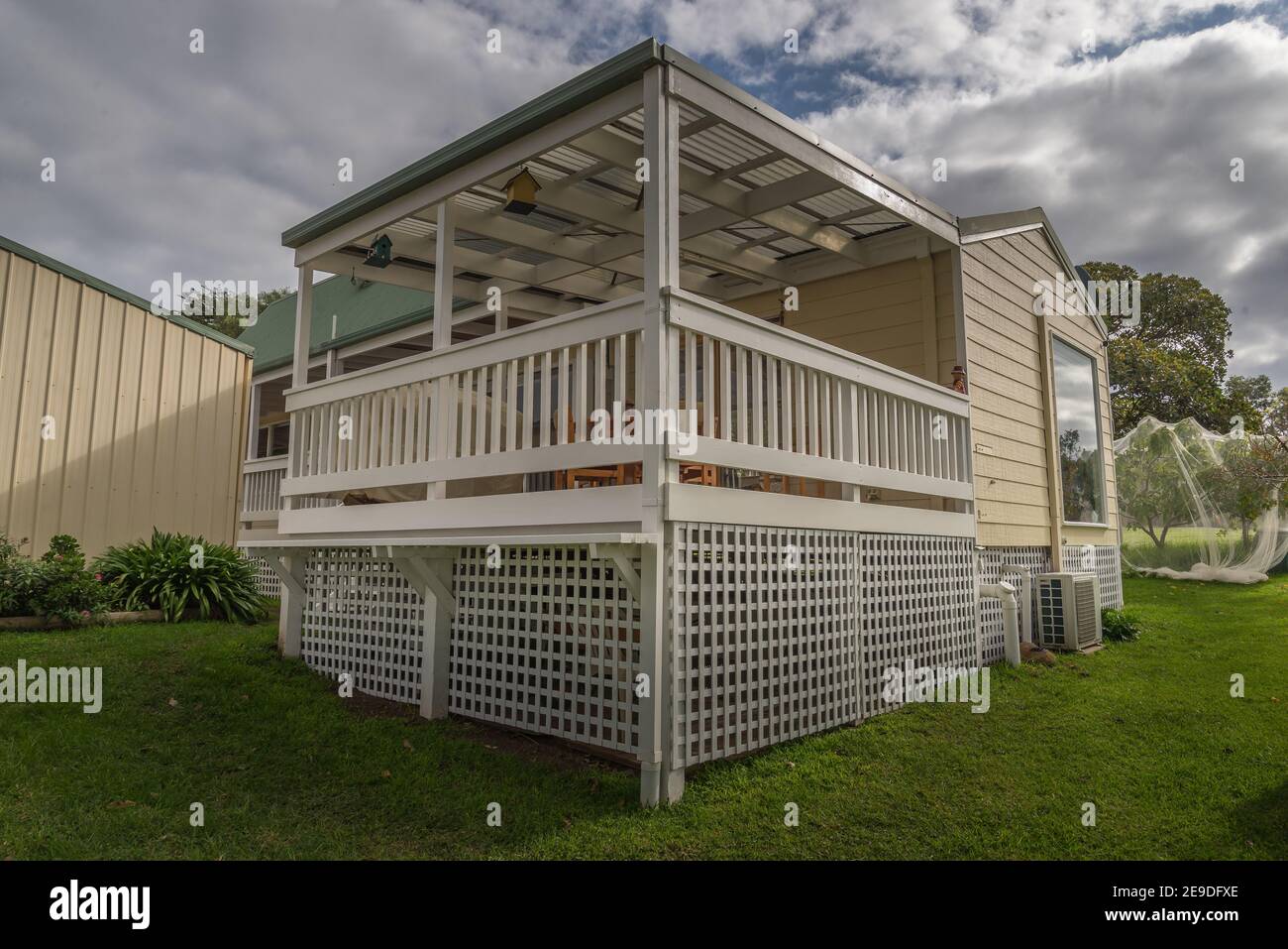 Under Deck Lattice painted white hiding posts Stock Photo - Alamy