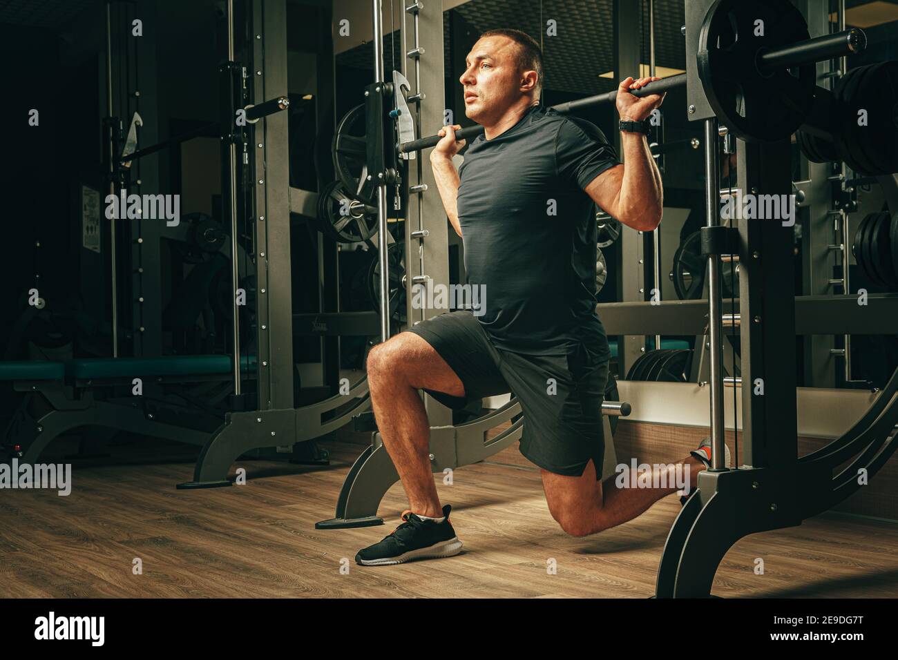 Male bodybuilder doing squats barbell hi-res stock photography and ...