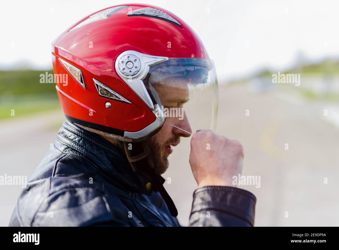 Young bike rider putting helmet hi-res stock photography and images - Alamy