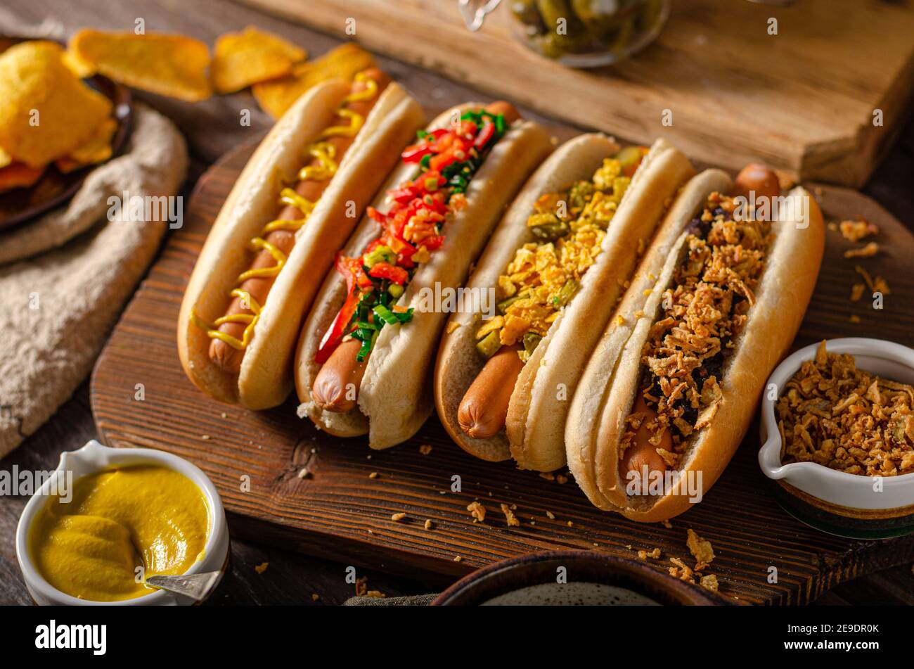 Delicious and simple hot dogs with mustard, pepper, onion and nachos ...
