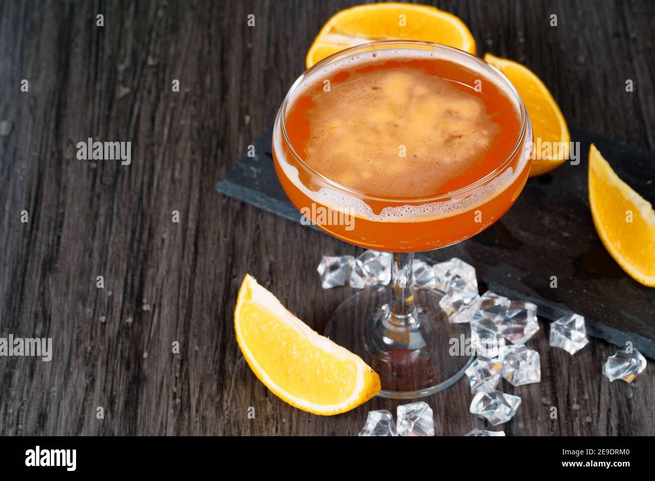 Two beautiful cocktails served on a wooden bar counter Stock Photo - Alamy