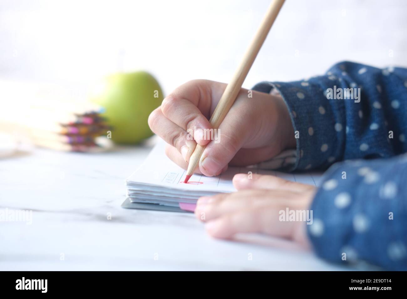 Close up of a child hand drawing with colored pencil on a page Stock ...