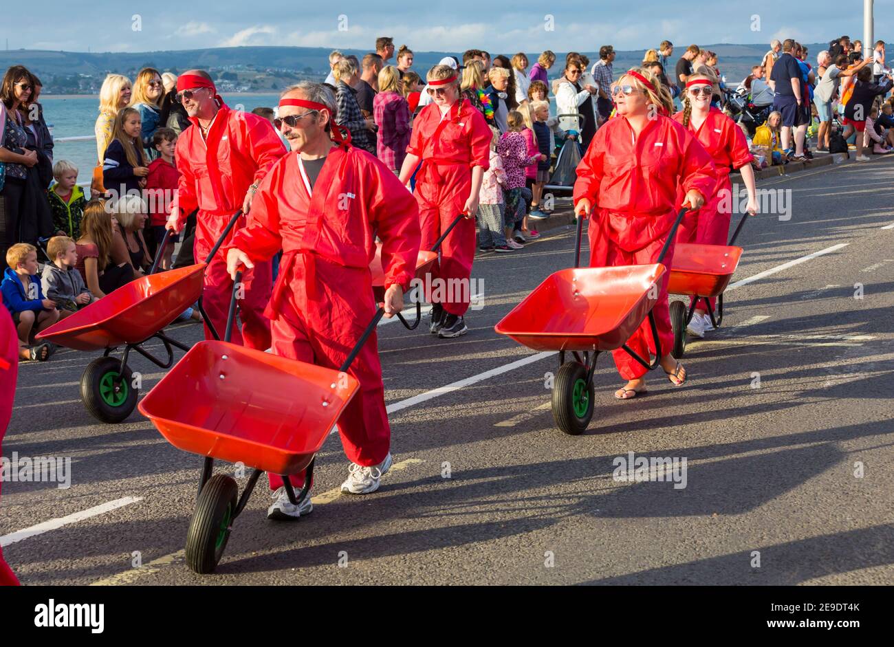 The Red Barrows, a take on the Red Arrows, push their wheelbarrows ...