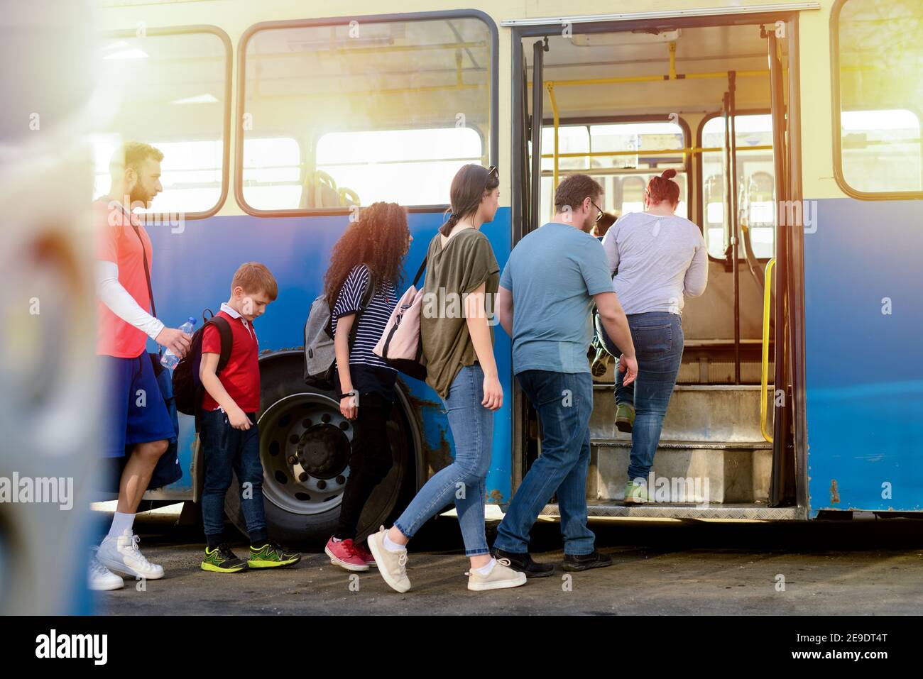 Group of people entering in to a bus in a bus station Stock Photo - Alamy