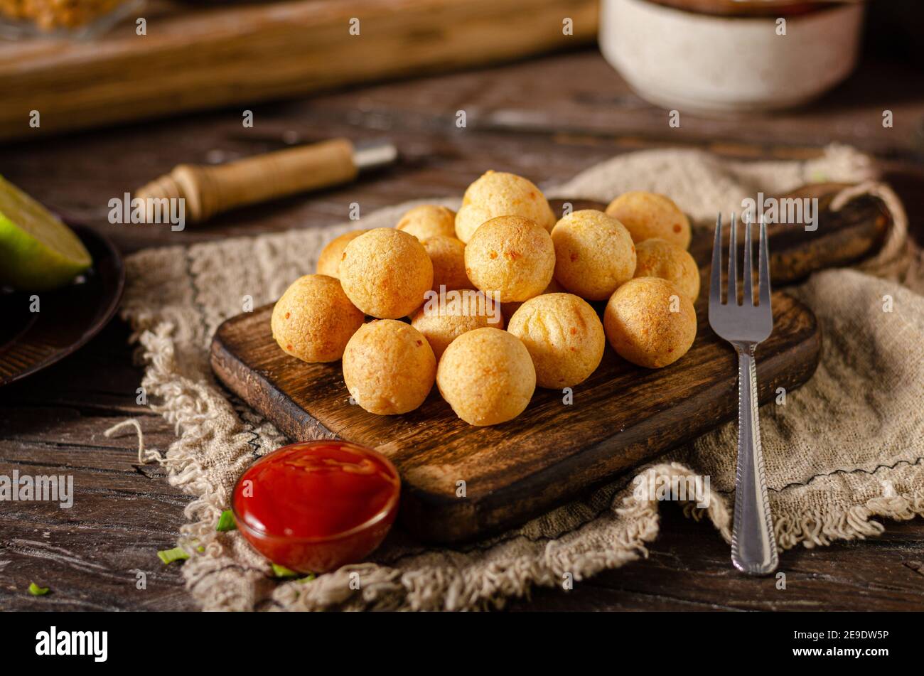 Rounded croquettes with hot sauce and cheese Stock Photo - Alamy