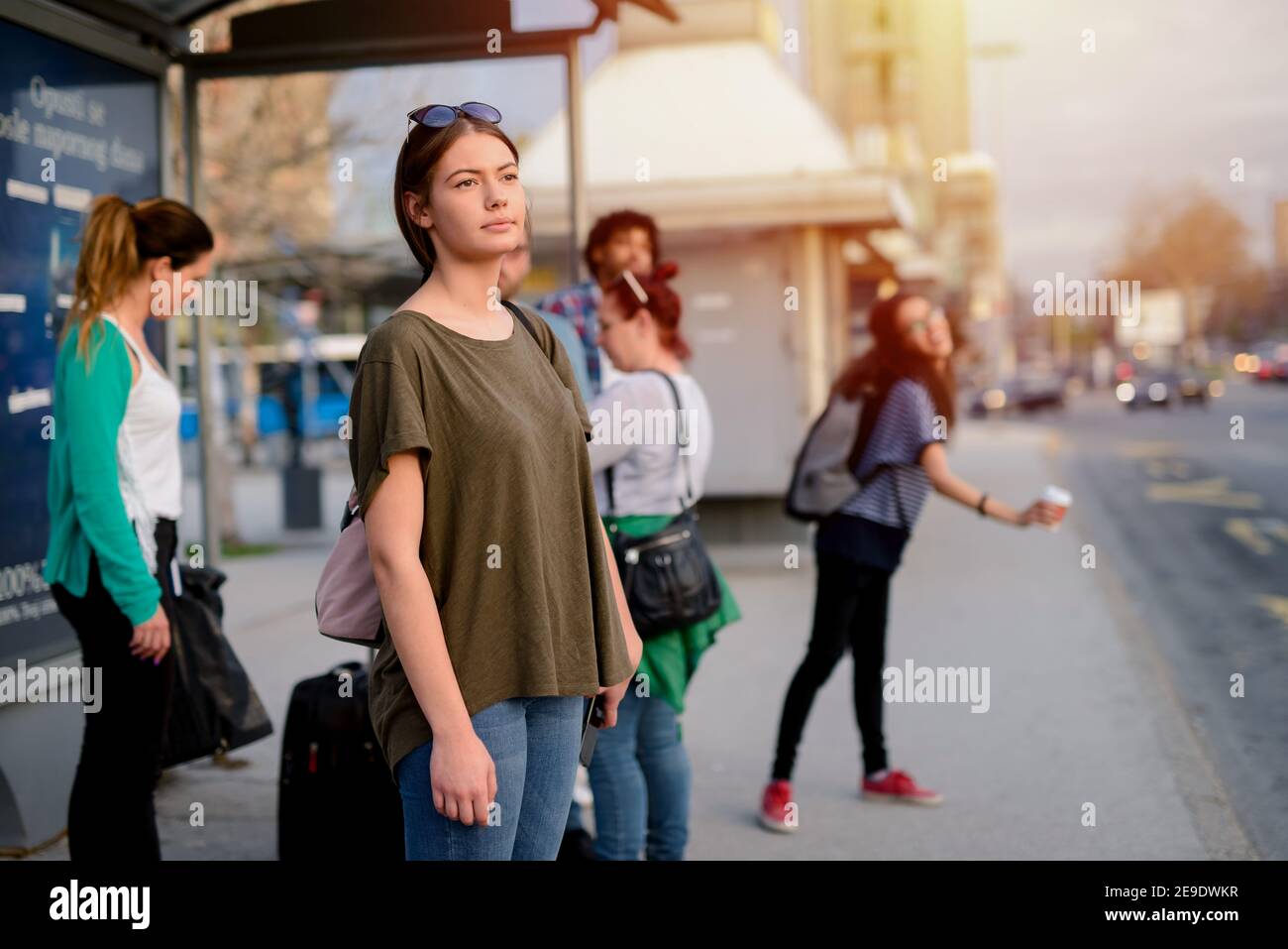 Group of people standing in a street and waiting for the transport ...