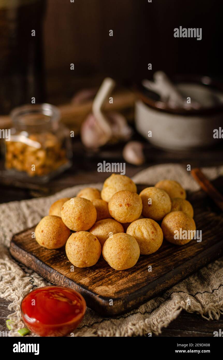 Rounded croquettes with hot sauce and cheese Stock Photo - Alamy