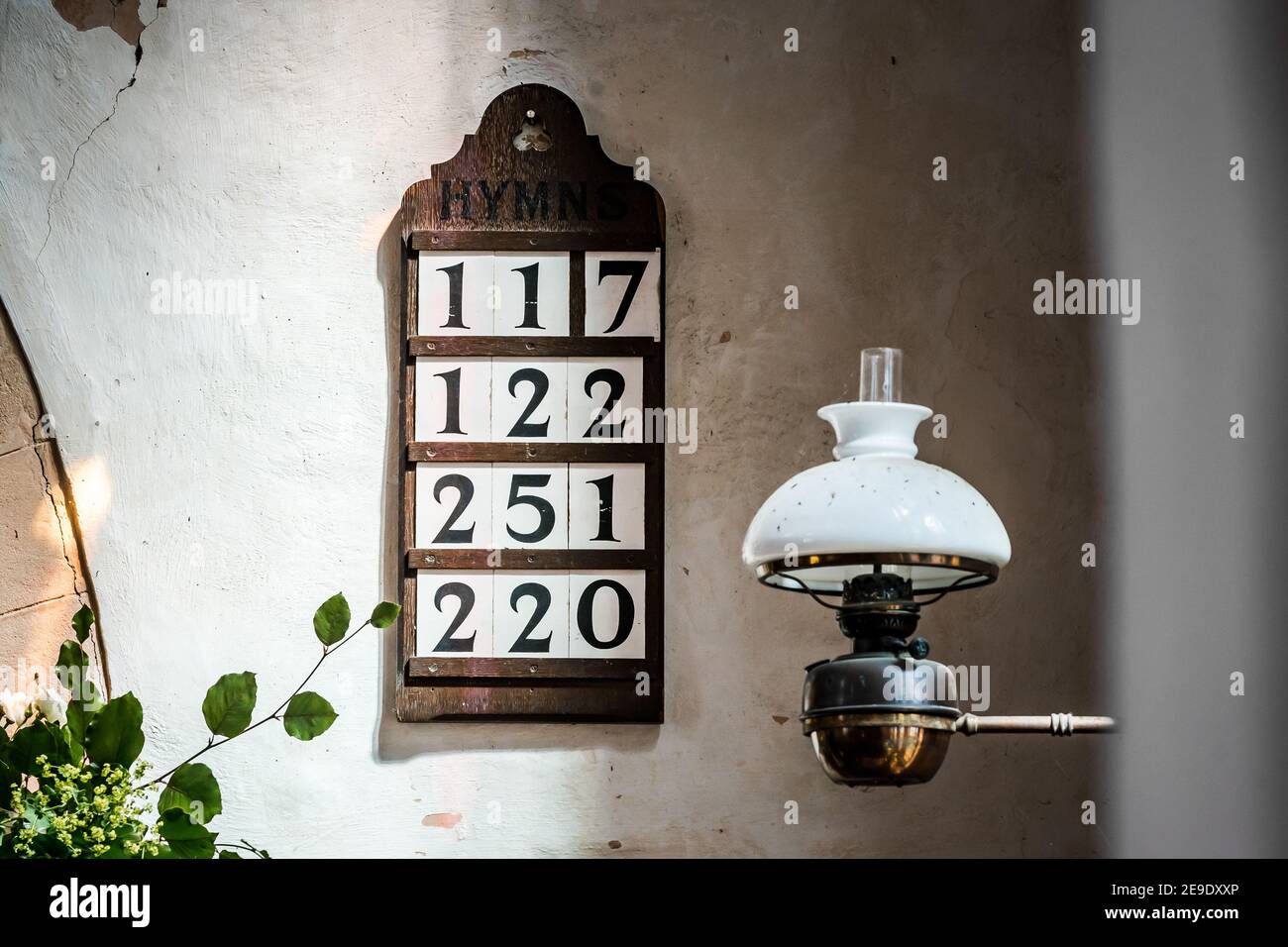Old dark oak wooden hymn board with four psalm numbers displayed on ...