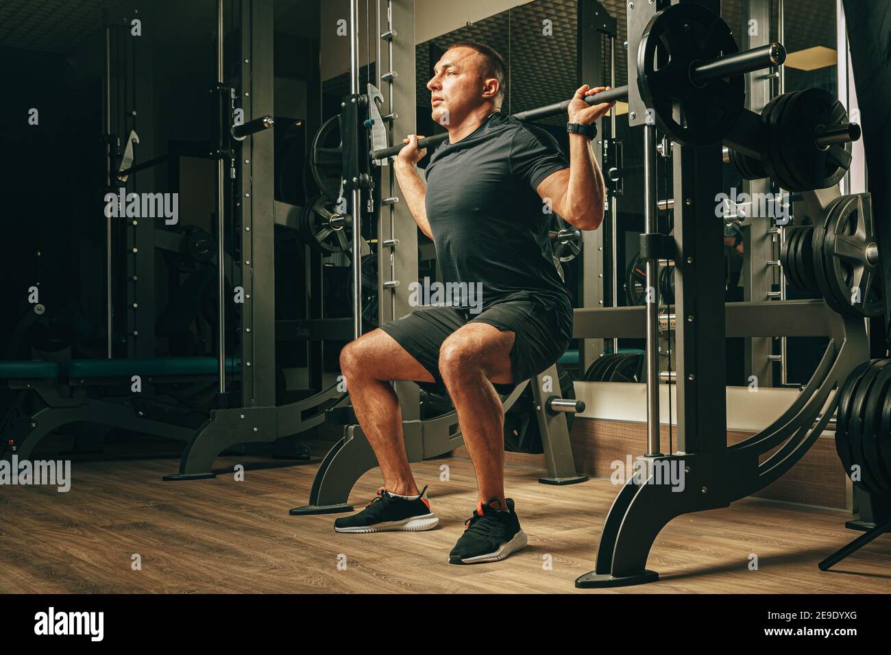 Squatting male model hi-res stock photography and images - Alamy