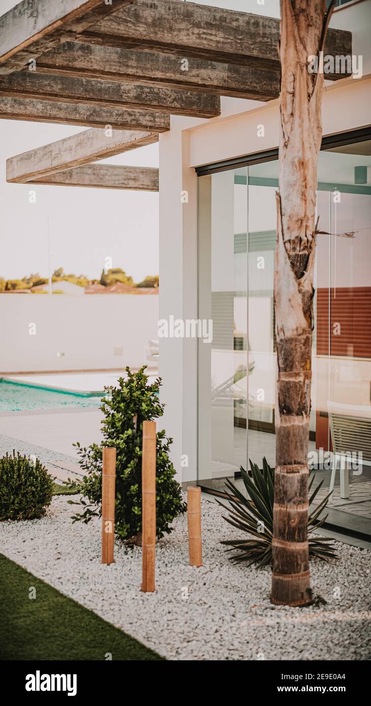 A modern contemporary resort house exterior design with glass walls and ...