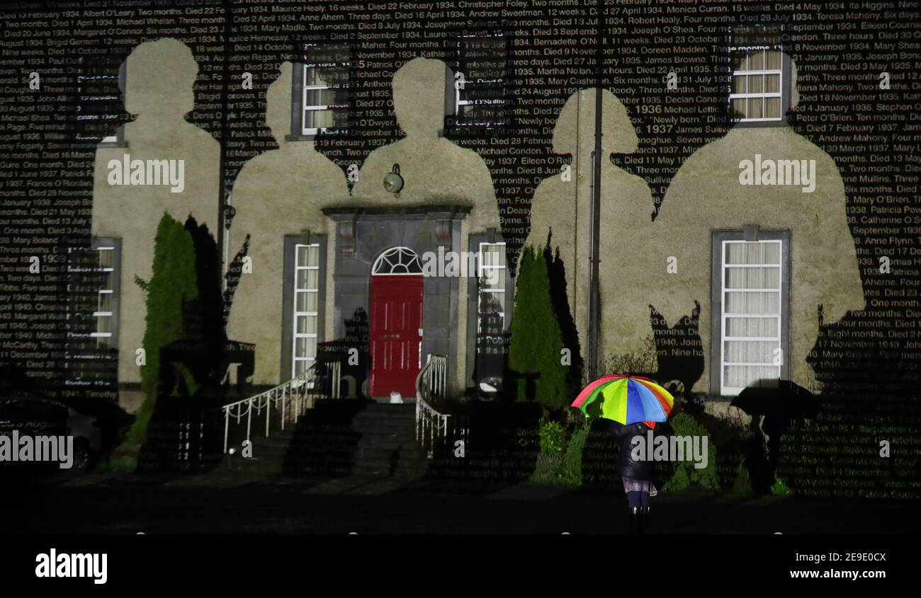 A woman looks at silhouettes of children projected onto Sean Ross Abbey ...