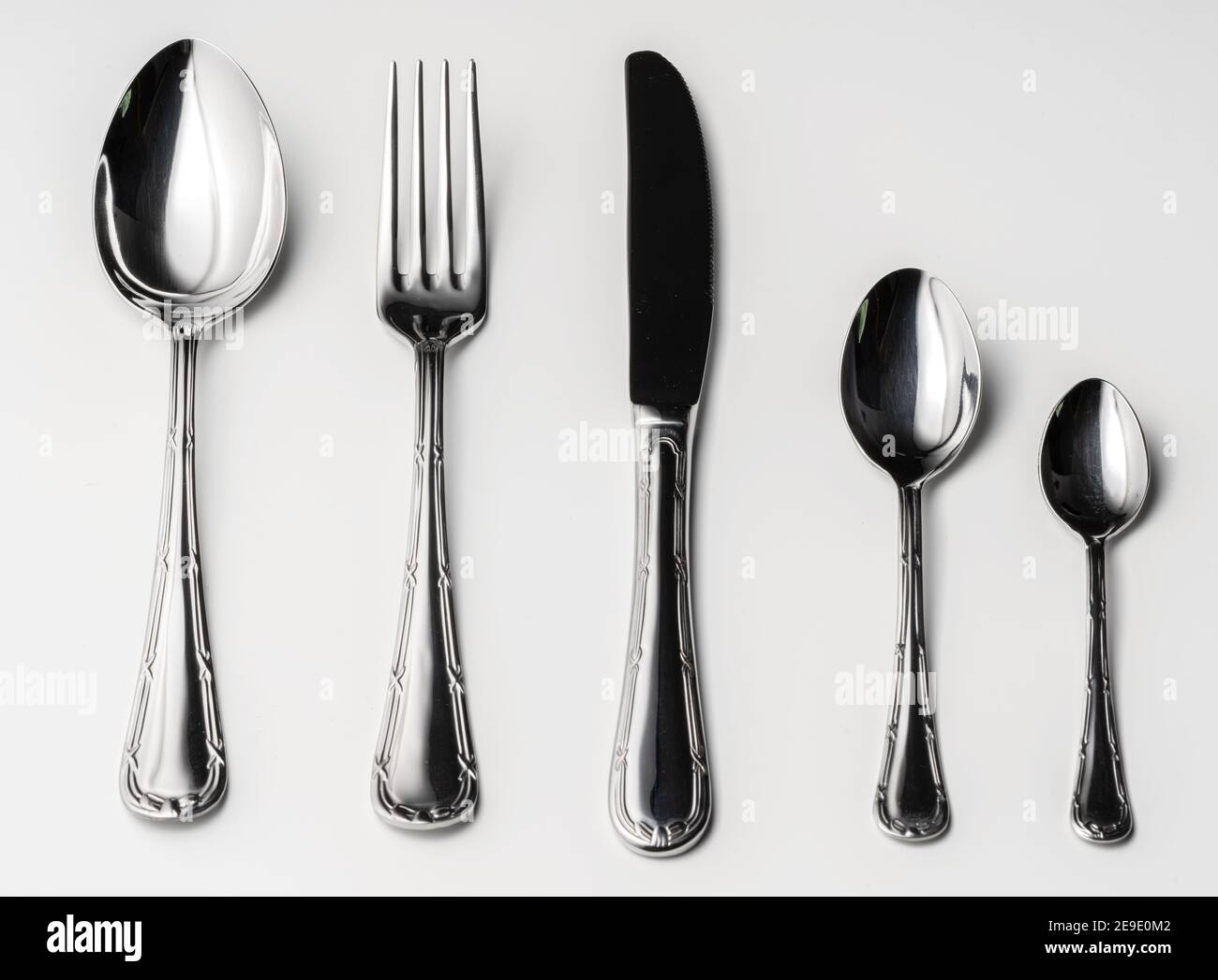 Set of silver cutlery on a white background Stock Photo - Alamy