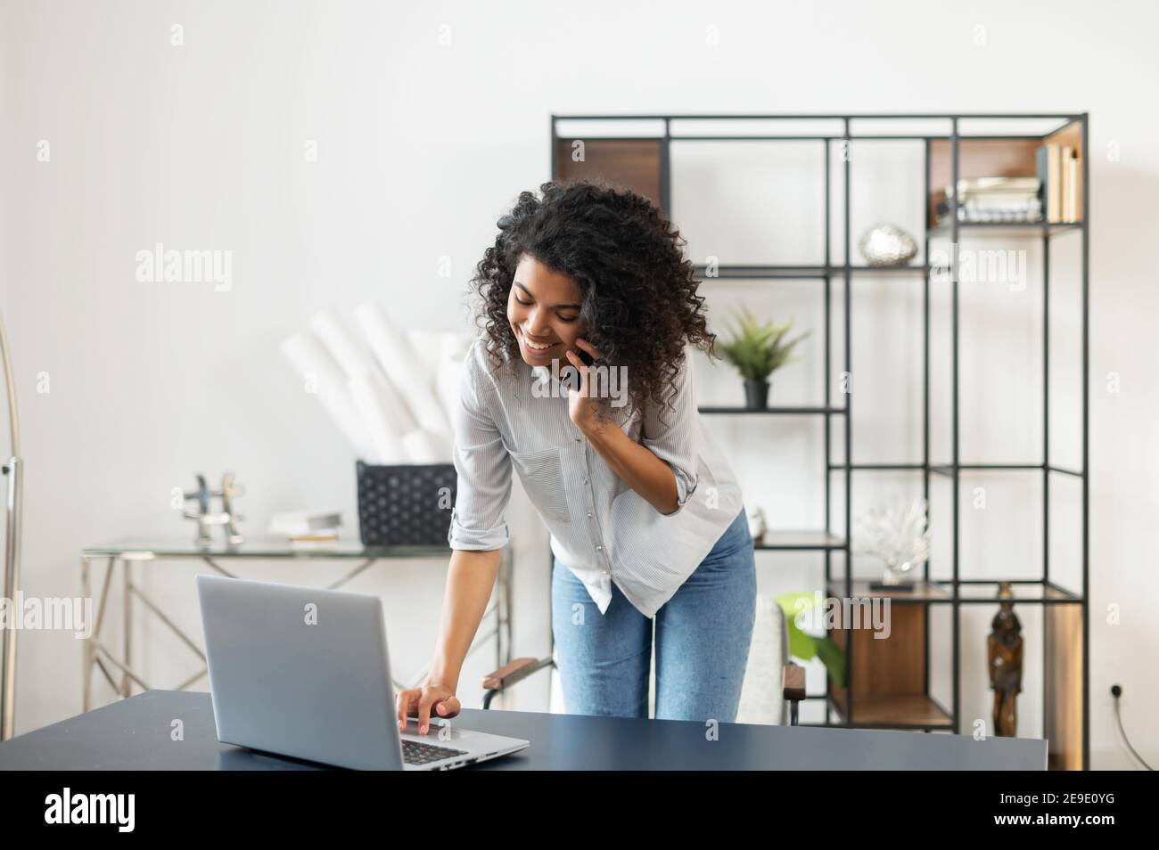 Busy multitasking young African American sales representative on a ...