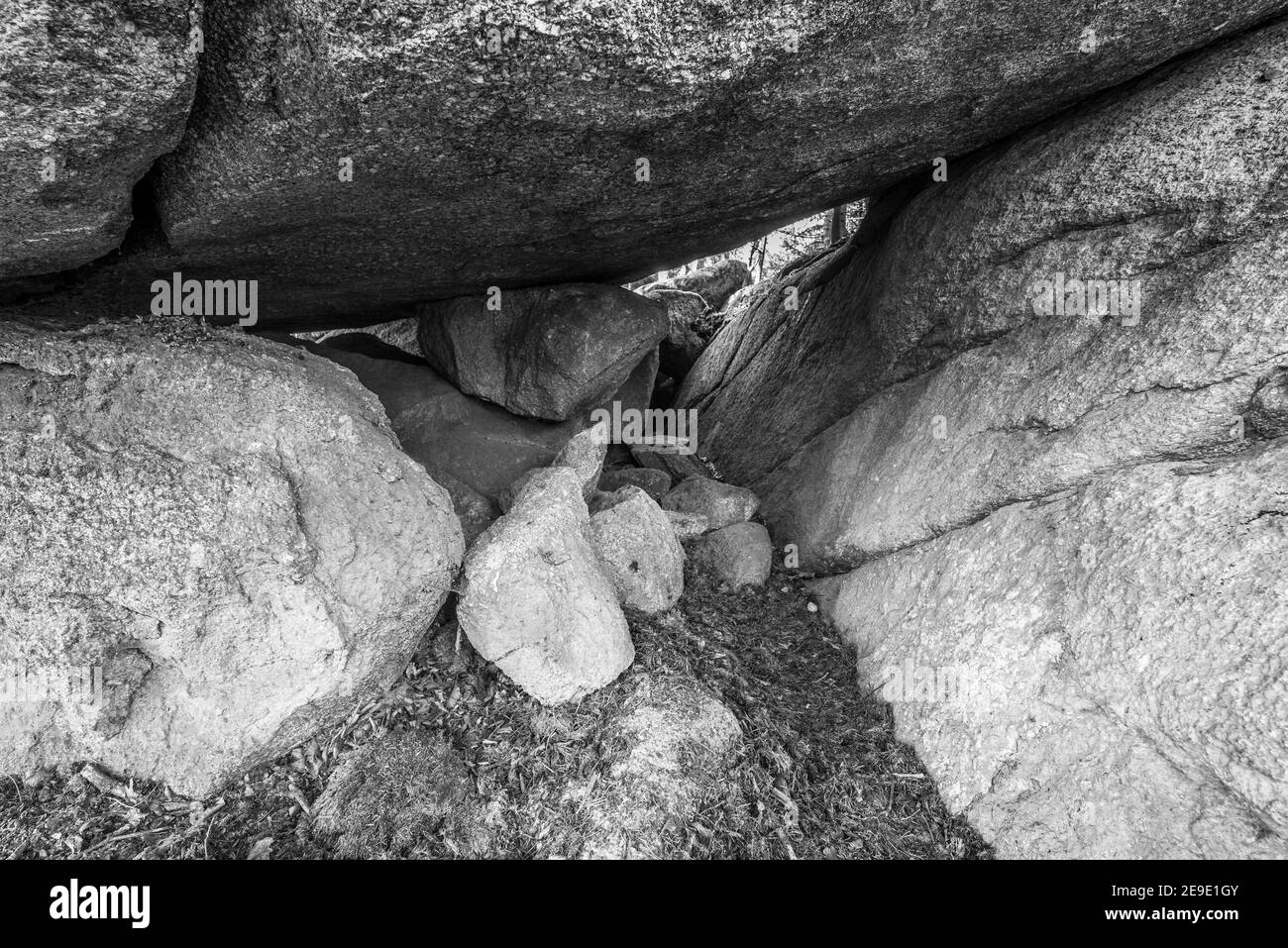 Ancient weathered megalithic granite rock formation with cave and ...