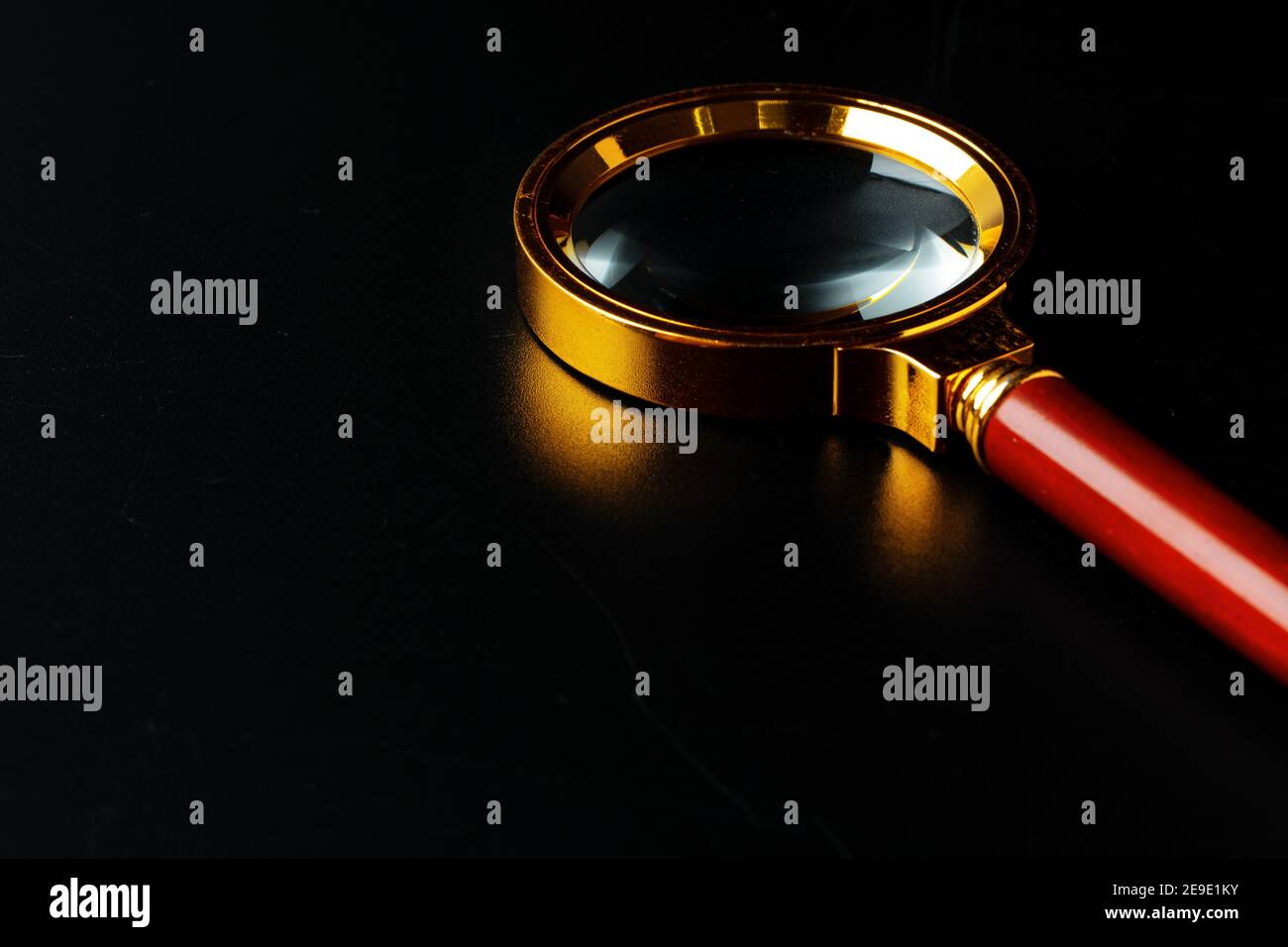 Magnifying glass close up on black background Stock Photo - Alamy