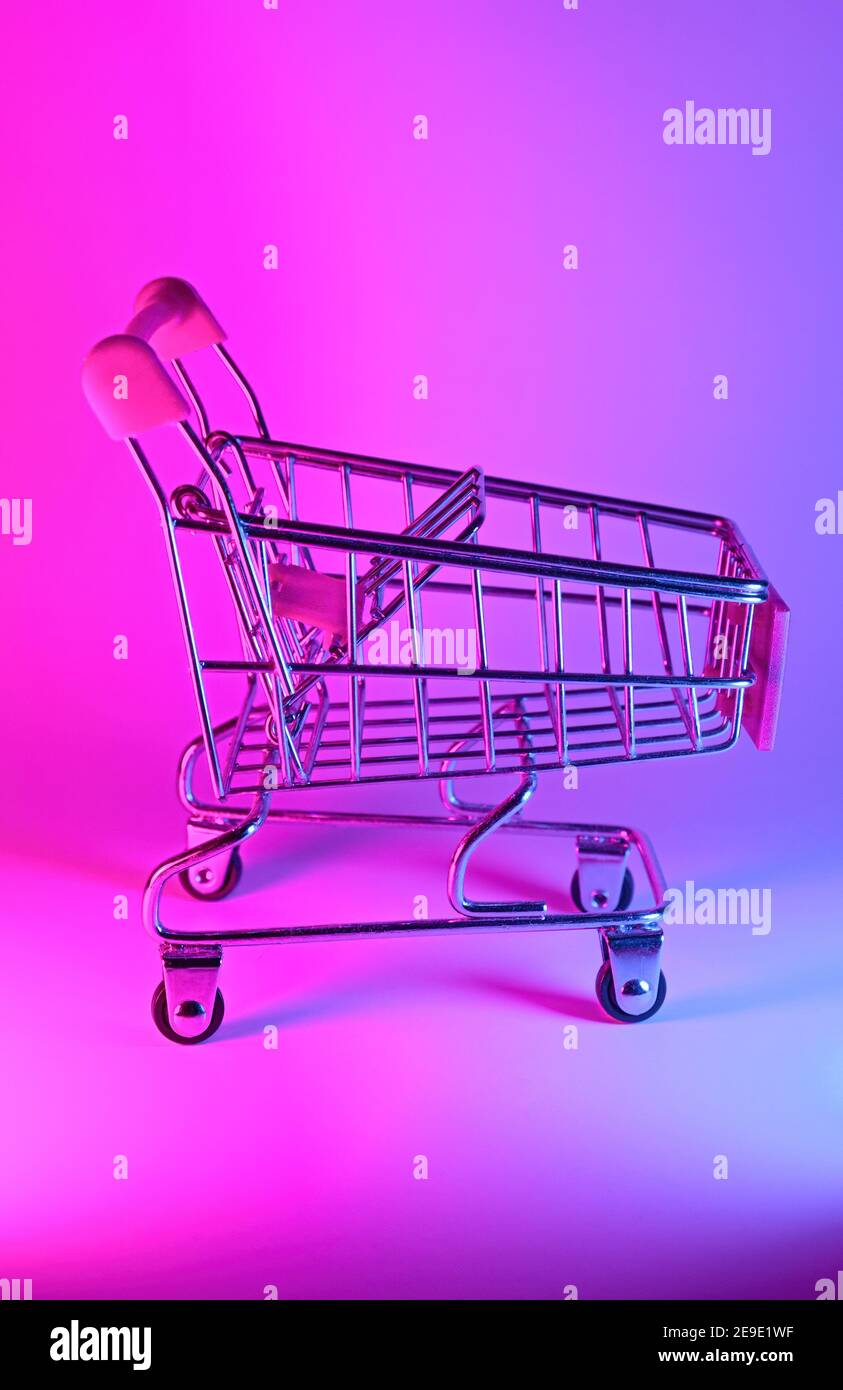 Shoping trolley with in trendy neon light. Gradient pink-blue glow ...