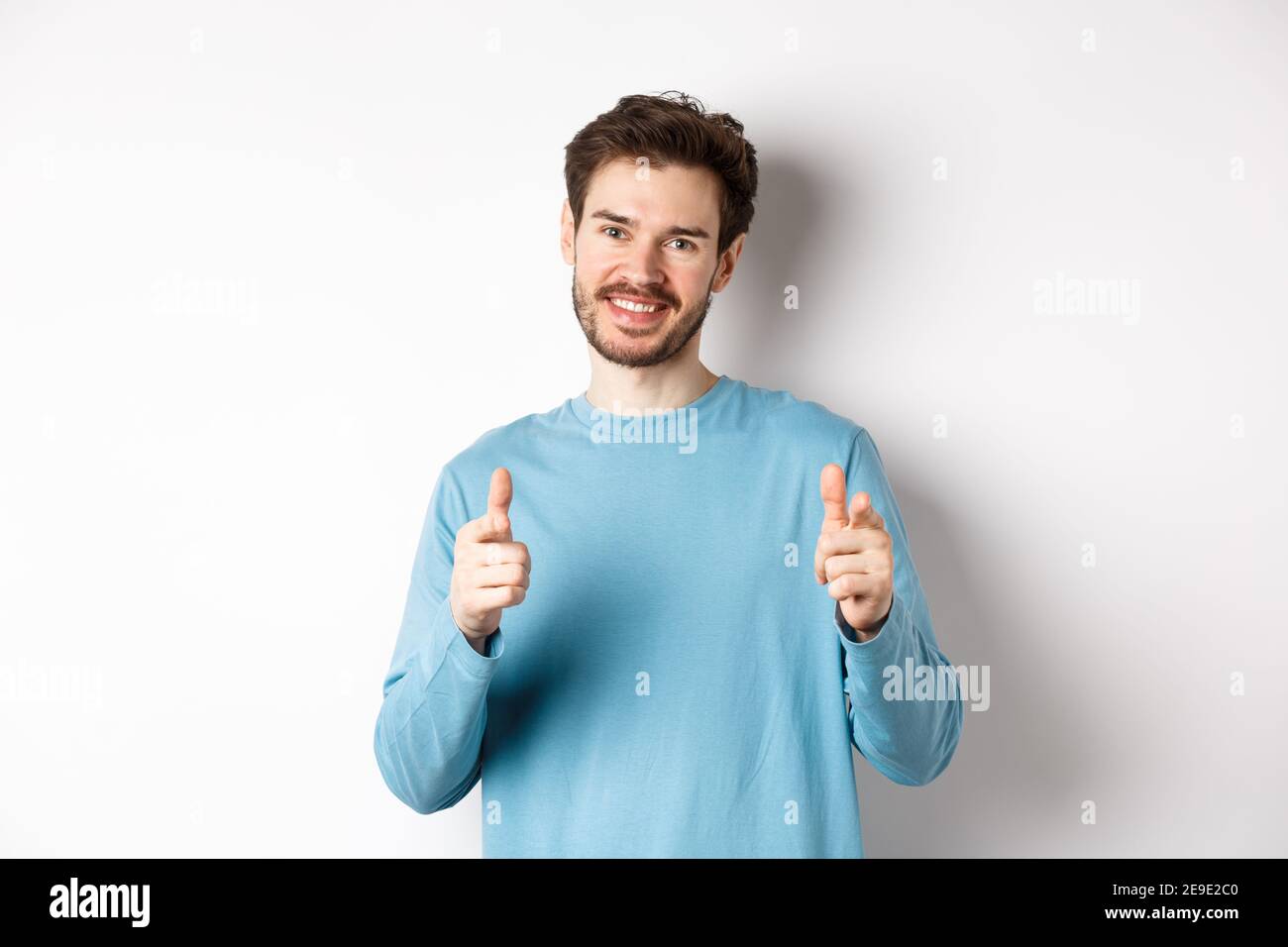 Well done. Smiling handsome man pointing fingers at camera to ...