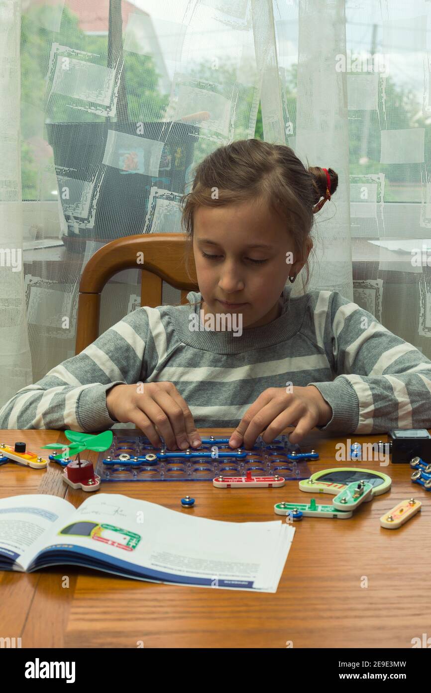 Close up kid hands creating toy from constructor. Toys of future ...