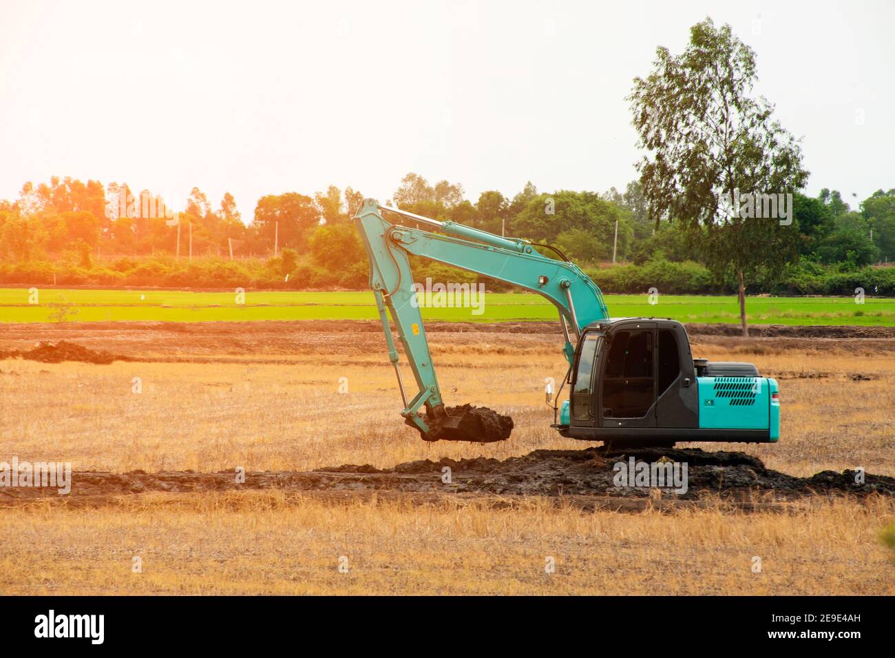 Excavator working at construction site. Backhoe digs ground for the ...