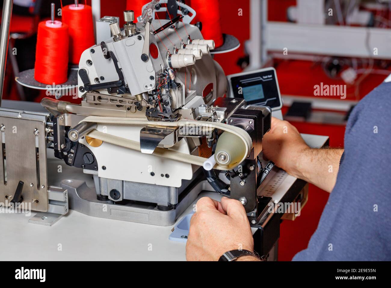 Sewing production, hands and craftsmen set up a modern electric sewing ...