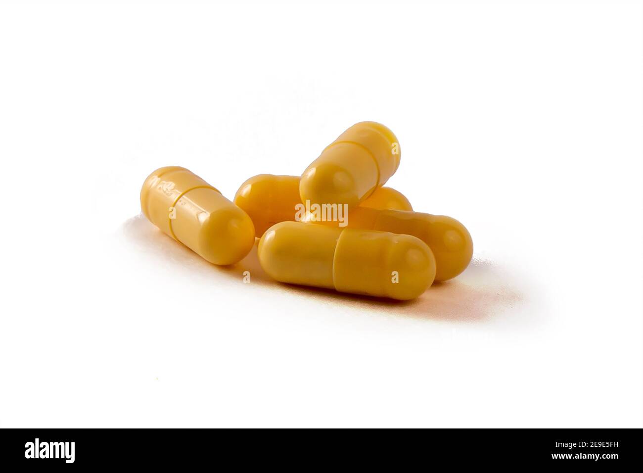 yellow medicine capsules with medicine , isolated on a white background ...