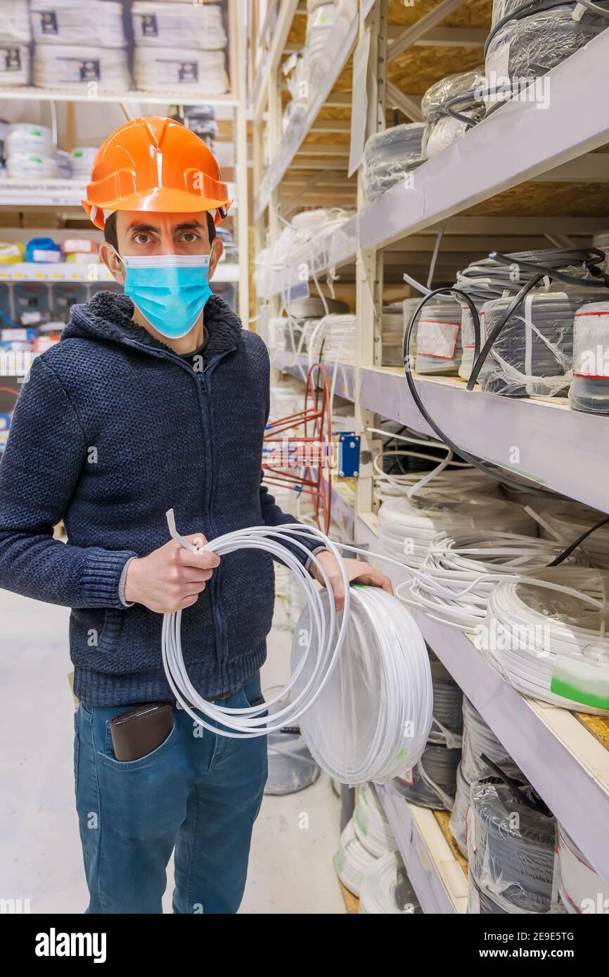 A man in a hardware store. Sells electrical cables. Selective focus ...