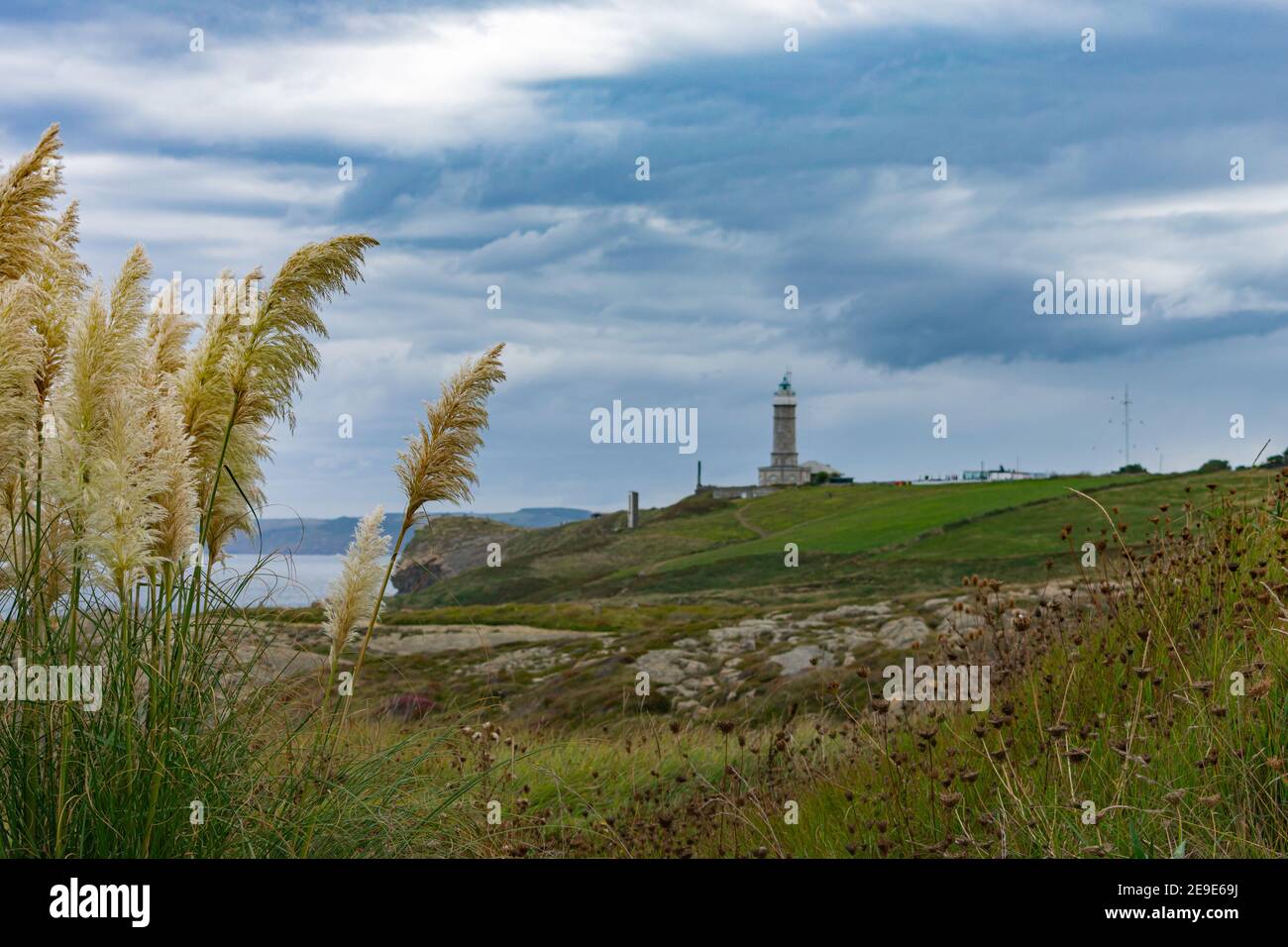 Beautiful scenery of the sea with the view of the lighthouse and field ...