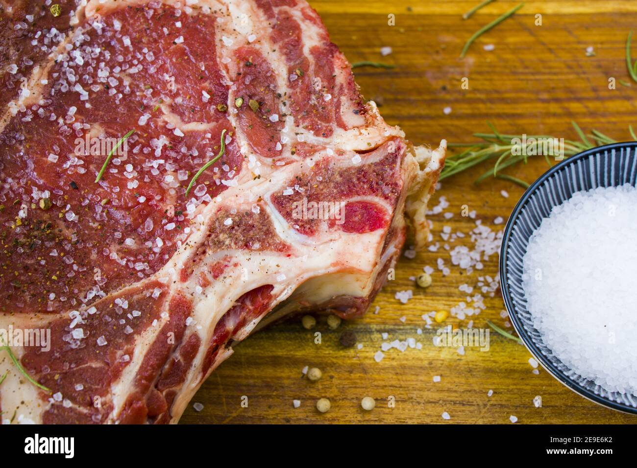 Lump of raw beef meat on a wooden surface with spices and herbs Stock ...